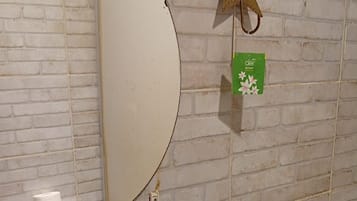 Uma casa de banho com uma pia branca, um espelho, uma sanita e uma estrela decorativa na parede.