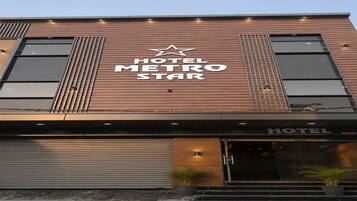 Um edifício moderno com uma placa que diz 'HOTEL METRO STAR'.