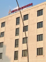 Um edifício com uma placa que diz 'HOTEL GOLDEN VERA' e várias janelas.
