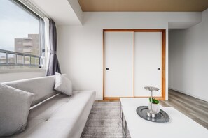 Uma sala de estar moderna com um sofá, uma mesa de centro e uma porta deslizante.