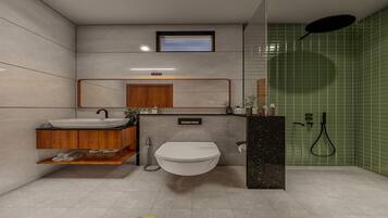 Uma casa de banho moderna com sanita, lavatório e chuveiro.