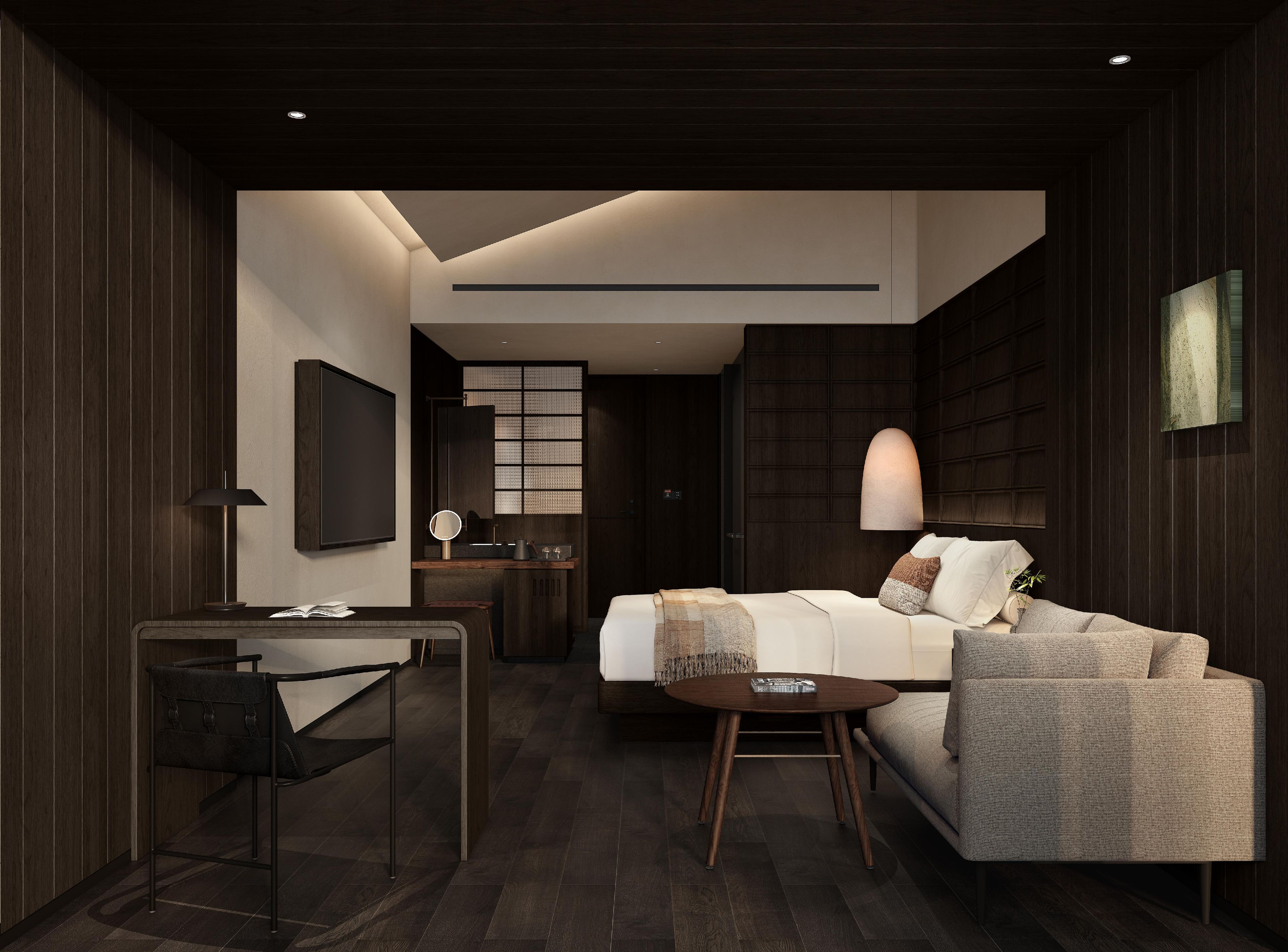 Quarto de hotel moderno com cama, escrivaninha, cadeira, mesa redonda e televisão.