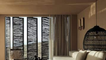 Quarto moderno com uma cama grande, luminária pendente e vista pela janela.