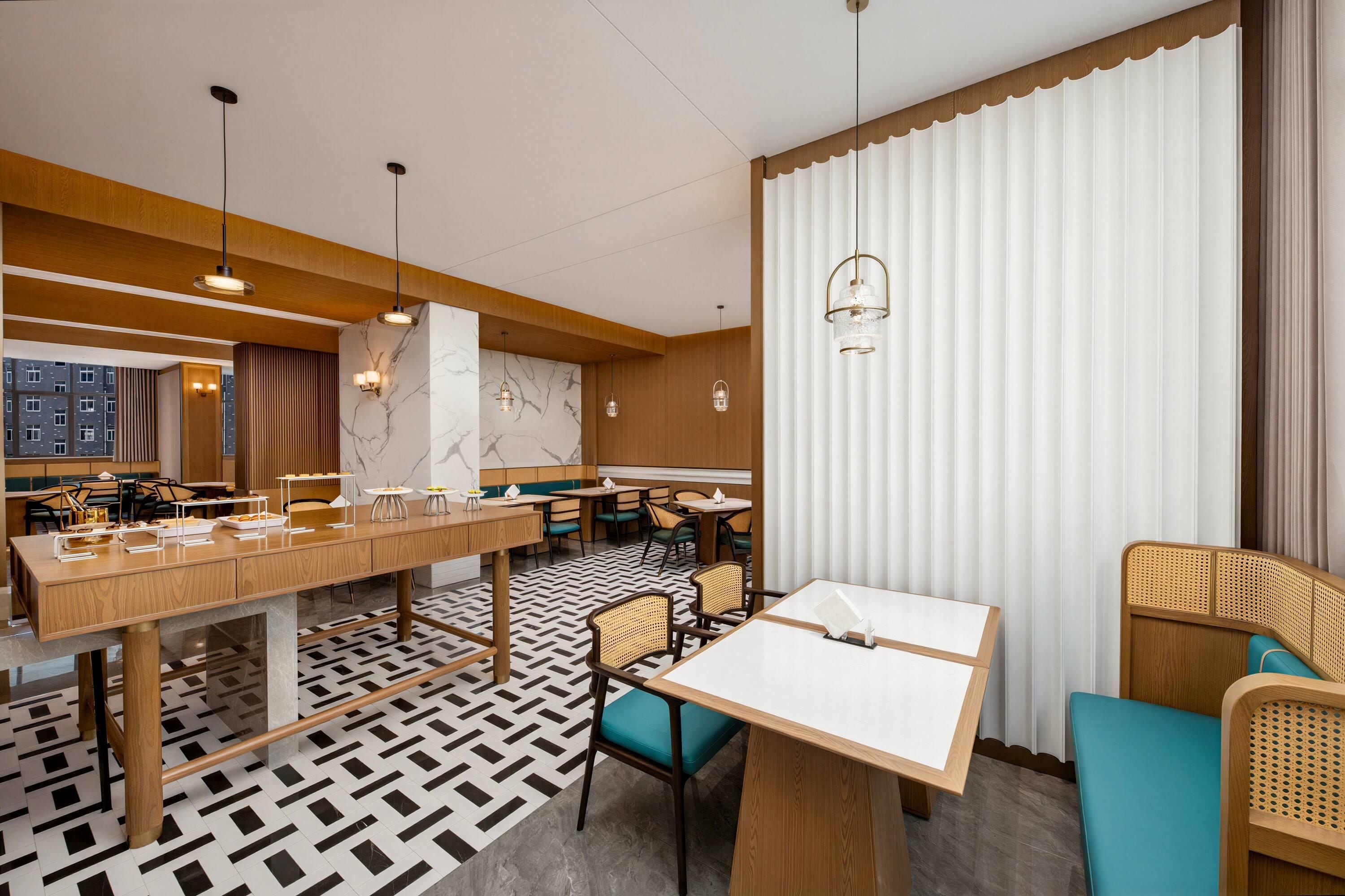 Um restaurante moderno com uma mesa grande para vários convidados, mesas individuais e um chão com padrão.