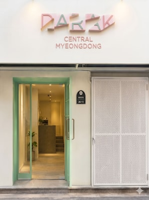 Entrada de um edifício com uma placa indicando 'PARAK CENTRAL MYEONGDONG'.