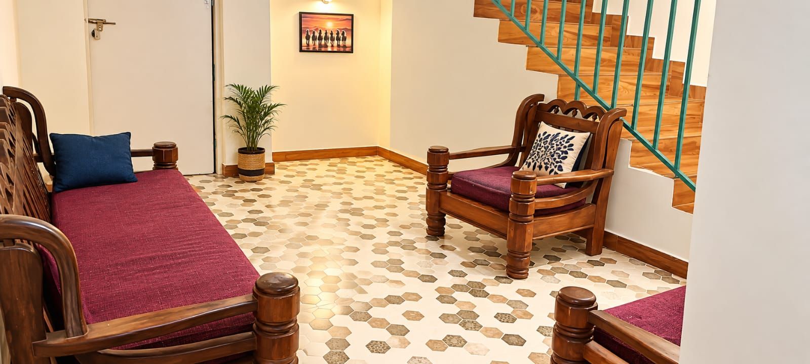 Quarto com cama de madeira, cadeira de madeira com almofada, planta em vaso e escada com degraus de madeira e corrimão verde.