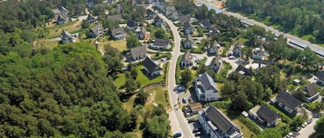 Um bairro residencial com casas, ruas e uma orla costeira.