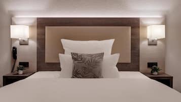 Quarto de hotel com uma cama grande, duas luminárias de cabeceira, um telefone e uma pequena planta em cada mesa de cabeceira.
