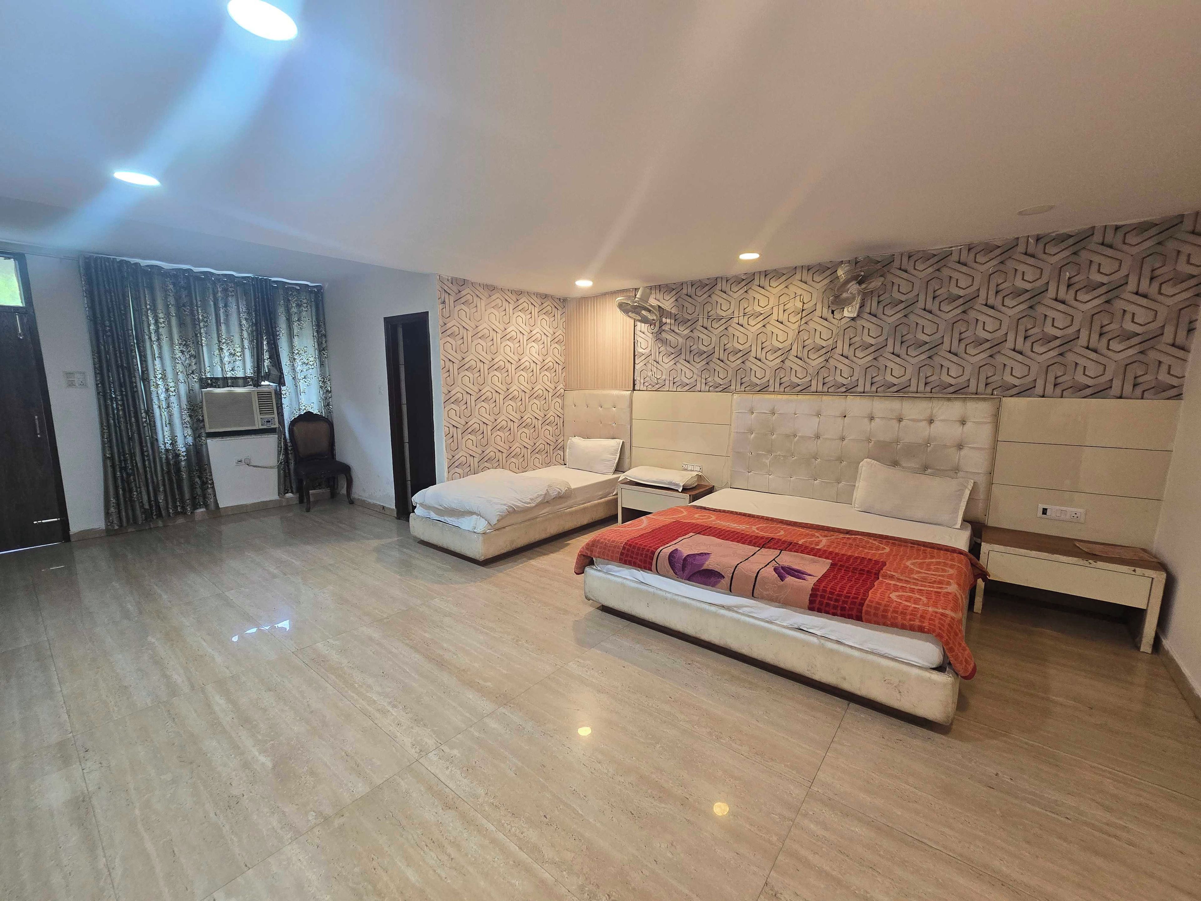 Quarto com cama grande, mesa de cabeceira, guarda-roupa e parede estampada.