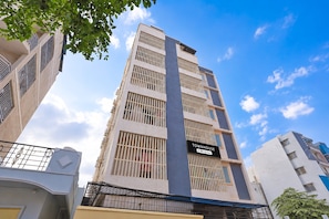 Edifício de vários andares com placa indicando ser um apartamento por temporada.