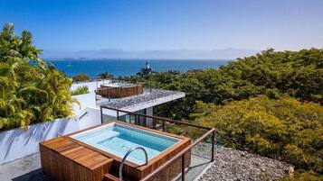 Piscina no terraço com vista clara para o mar e montanhas.