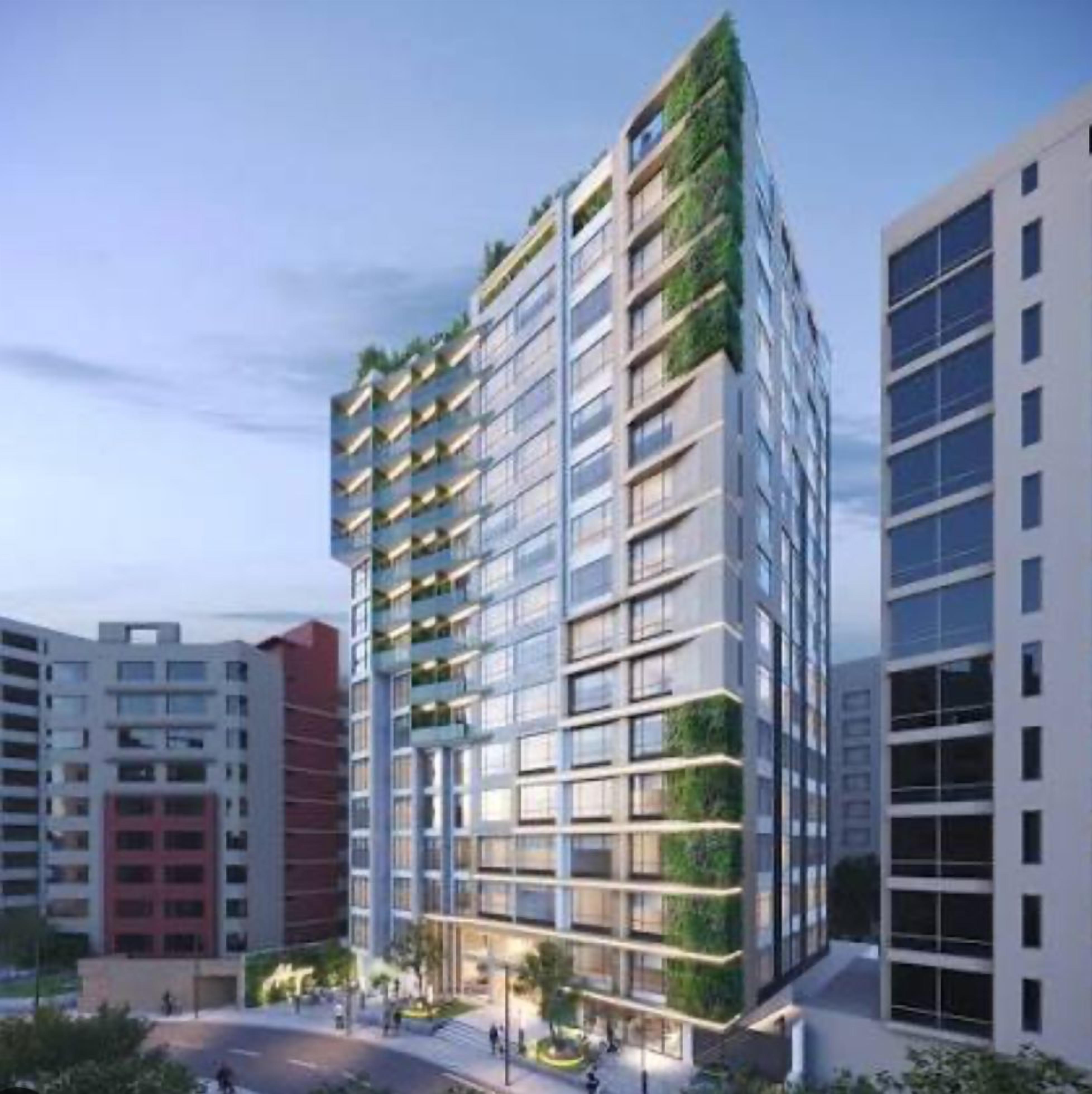 Um edifício moderno e imponente com várias varandas, cercado por outros edifícios.