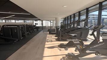 Uma academia com equipamentos de ginástica, amplas janelas e piso de madeira.