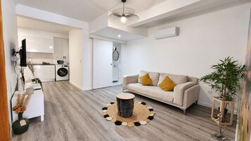 Uma sala de estar moderna com um sofá, uma mesa de centro e um tapete decorativo.