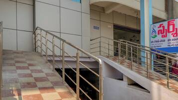 Uma escadaria com corrimão de metal que leva a um andar superior.