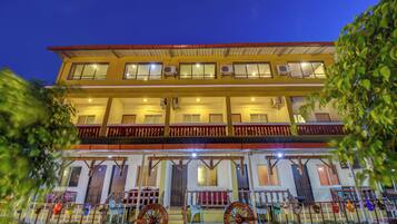 Um edifício de vários andares com varandas e aparelhos de ar condicionado.