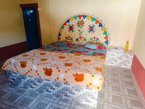 Uma cama com colcha estampada e cabeceira com design floral colorido.