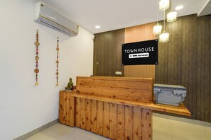 Bancada de recepção com uma placa indicando serviço OYO.