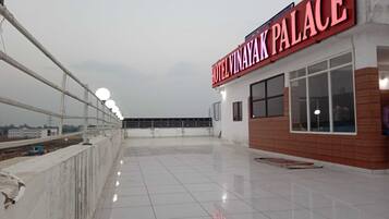 Um hotel chamado 'Hotel Vinayak Palace' com piso de azulejos e vista desobstruída da área ao redor.