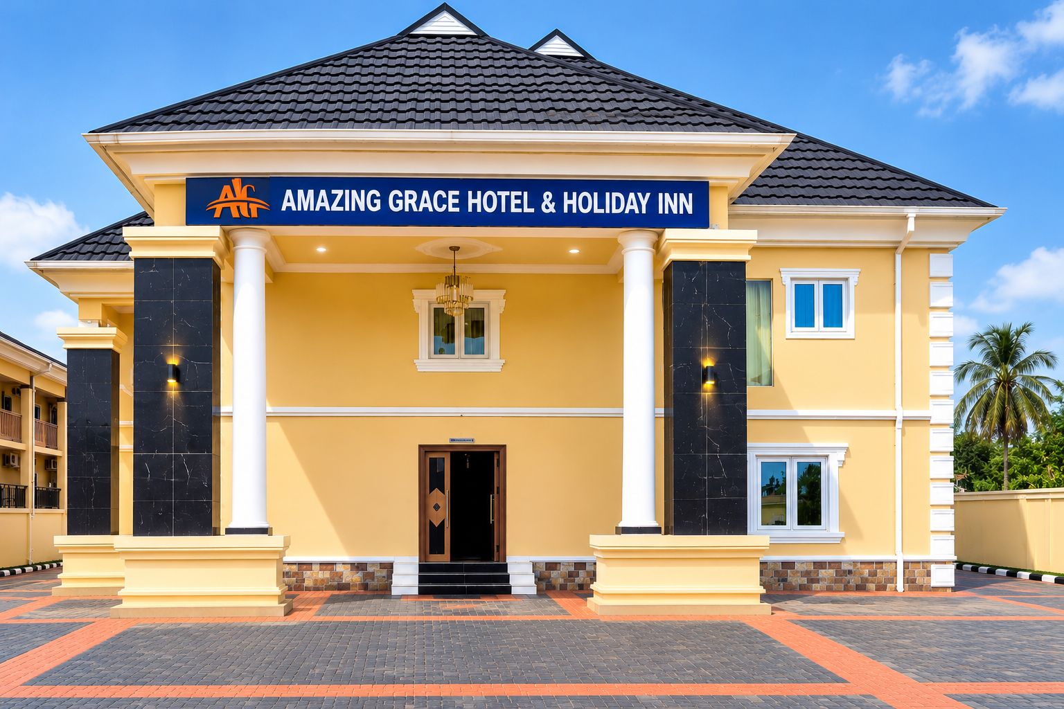 Um edifício de dois andares com uma placa indicando 'AMAZING GRACE HOTEL & HOLIDAY INN'.