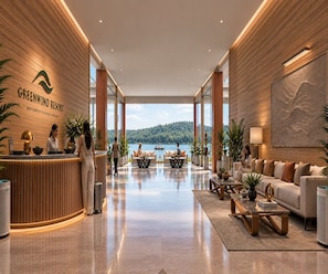 Um hall amplo com balcão de atendimento, área de estar e vista para um lago.