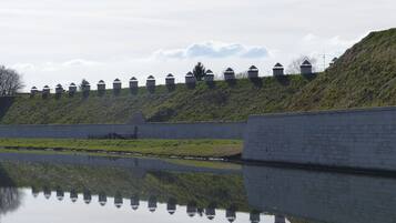 Uma construção fortificada com várias torres de vigia e um fosso.