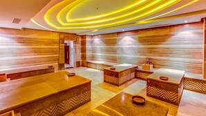 Um lobby de hotel moderno com balcão de recepção, áreas de estar e paredes estampadas.
