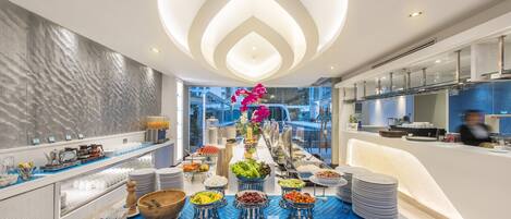 Um buffet de café da manhã moderno em hotel, com diversas opções de comida, um arranjo floral central e um design elegante e contemporâneo.