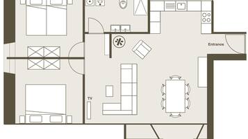 Planta baixa de um quarto de hotel com televisão, mesa de jantar, cozinha e entrada.