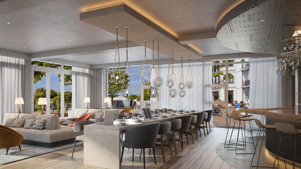 Cozinha moderna com ilha central, banquetas de bar e iluminação pendente.