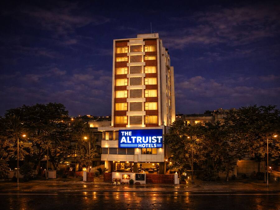 Um hotel com uma placa visível, vários andares e um design arquitetônico moderno.