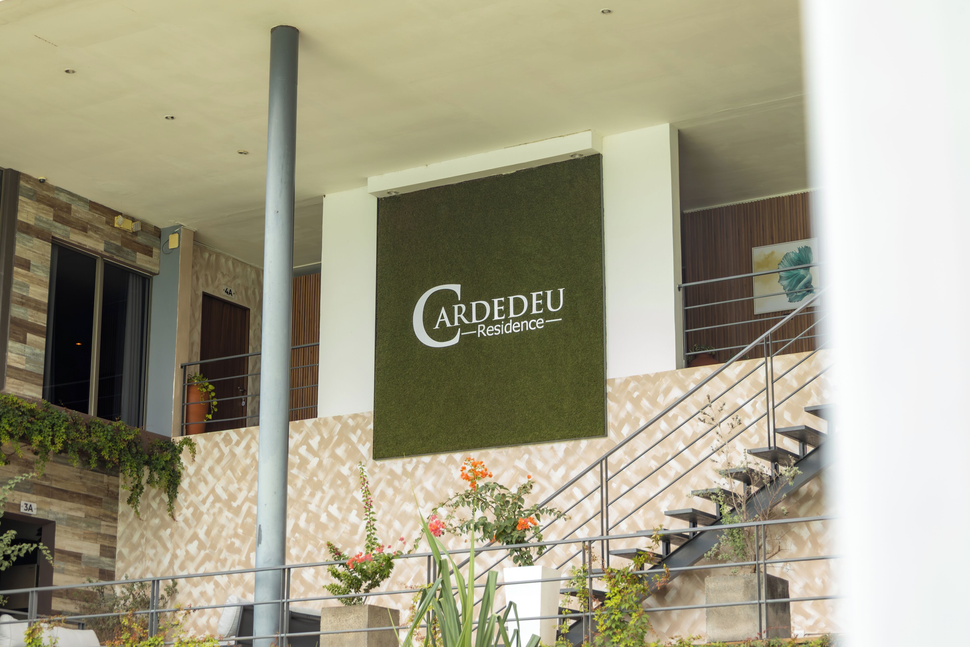 Entrada de hotel com uma placa que diz "Cardeau Residence".
