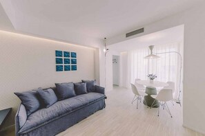 Suite, 1 quarto, varanda | Sala de estar | Televisor de ecrã plano de 32 polegadas com canais digitais, televisor 