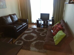 Apartamento, 1 quarto, vista para o oceano | Sala de estar | TV de ecrã plano 