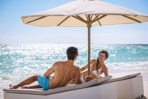 Uma praia privada, praia de areia branca, espreguiçadeiras 