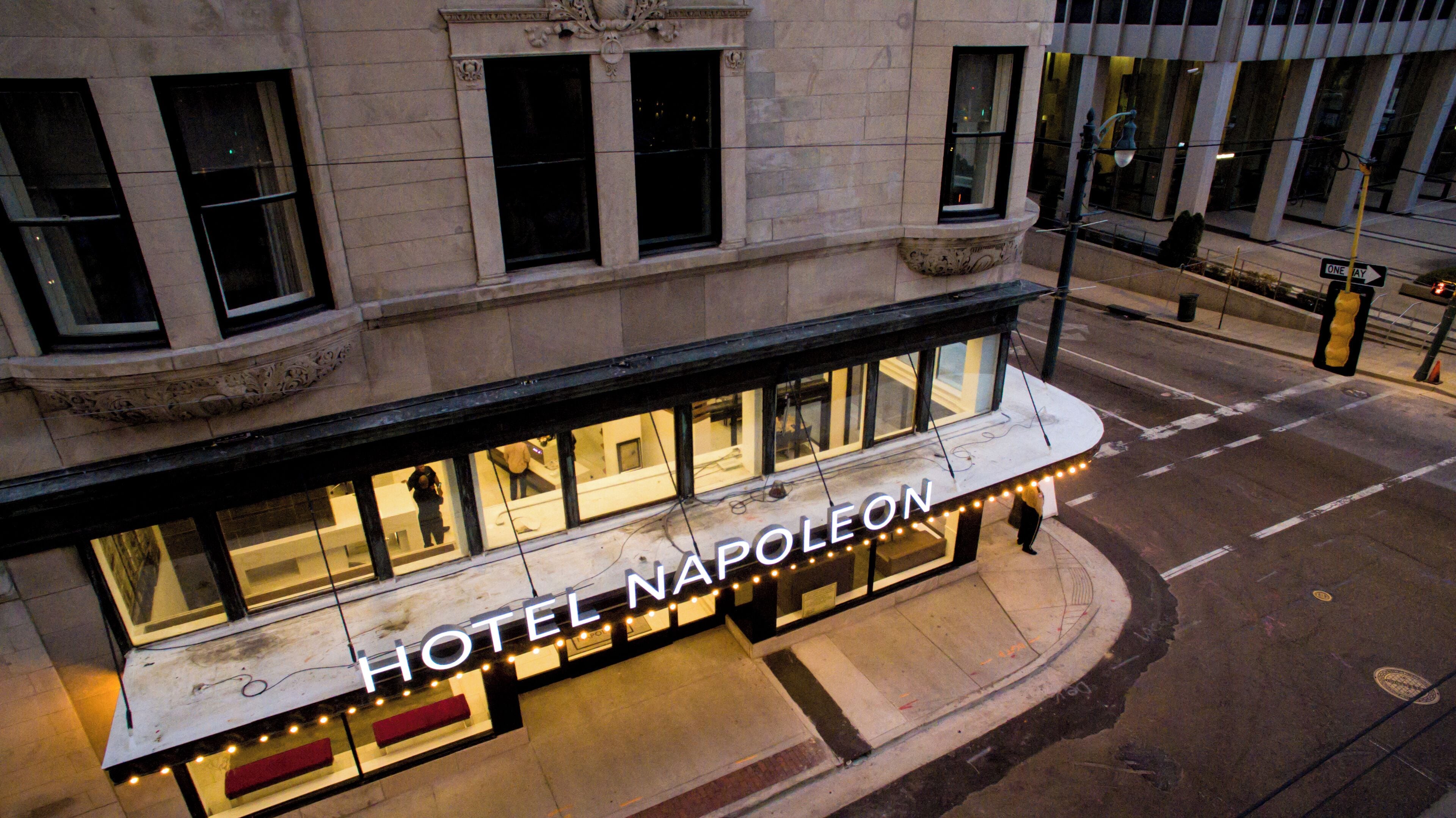 Exterior do Hotel Napoleon, com uma entrada destacada e vista clara da rua.