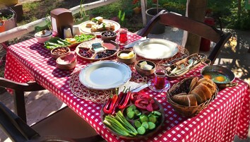 Mesa posta com diversos pratos e acompanhamentos, provavelmente para uma refeição.