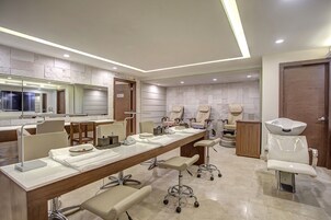 Uma clínica dentária moderna com um balcão de receção extenso, várias cadeiras de dentista e um interior limpo e bem iluminado.