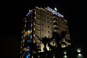 Um hotel de vários andares com um destaque para o letreiro 'Golden', indicando ser um estabelecimento de luxo.