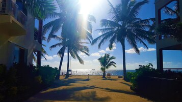 Na praia, espreguiçadeiras, toalhas de praia 