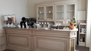 Uma cozinha com ilha central, armários e máquina de café.