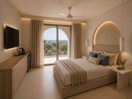 Quarto com uma cama grande, televisão, ventilador de teto e vista para o exterior.