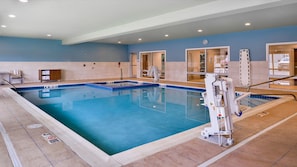 Piscina interna com cadeira de salva-vidas, sala de trocas e área de recepção.