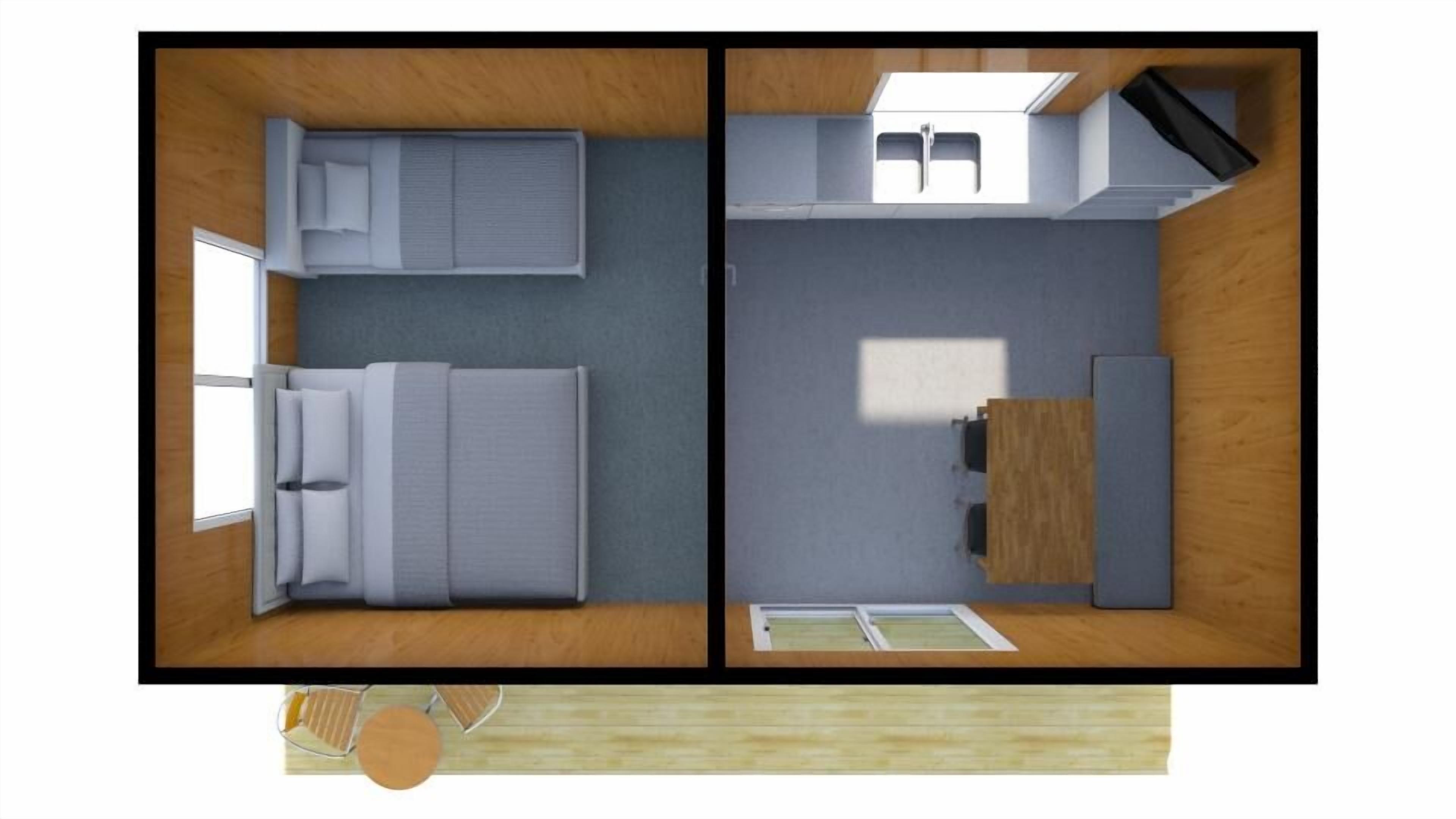 Quarto com uma cama, uma escrivaninha, uma cadeira e uma pequena mesa.
