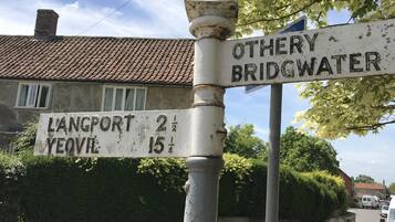 Uma placa de sinalização com indicações para 'Langport' e 'Yeovil', e 'Othery Bridgwater' em outra placa.