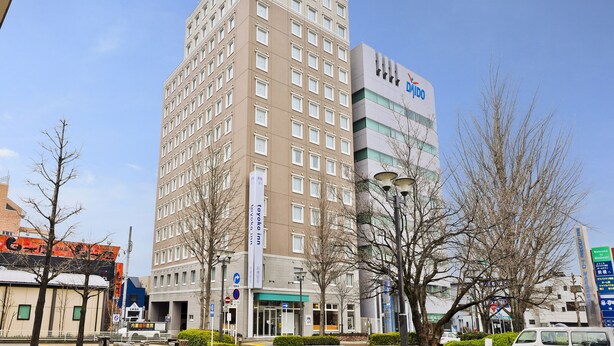 Um hotel com vários andares e um letreiro chamativo para Toyoko Inn.