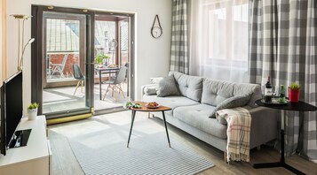 Cobertura galeria, 1 cama Queen e sofá-cama, vista para a cidade | Área de estar | TV de tela plana
