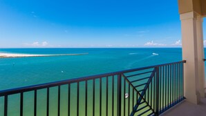 Varanda com vista para o oceano e céu claro.