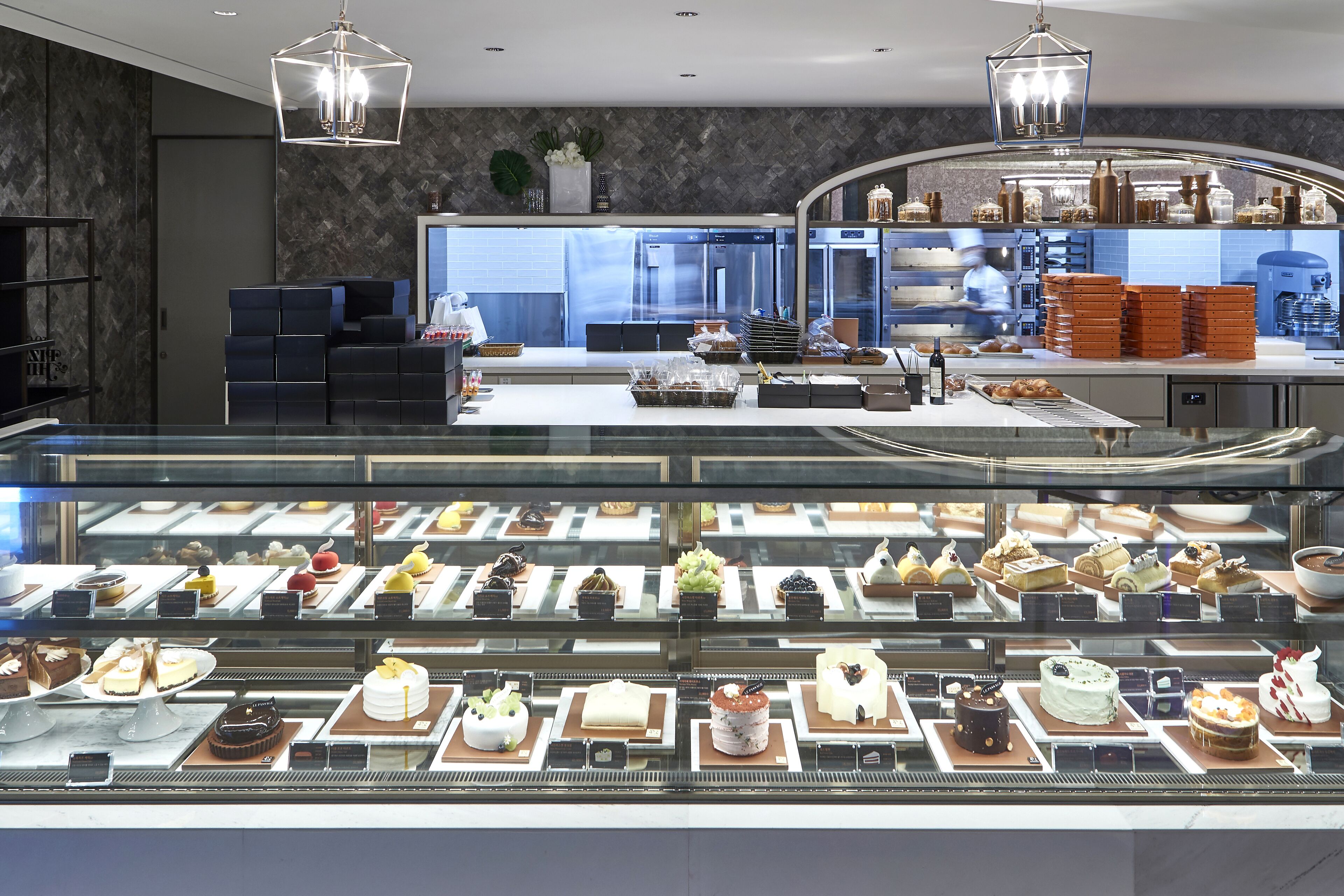 Vitrine de pastelaria com diversos bolos e doces.