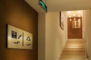 Uma escadaria com uma placa indicando um banheiro e um restaurante.